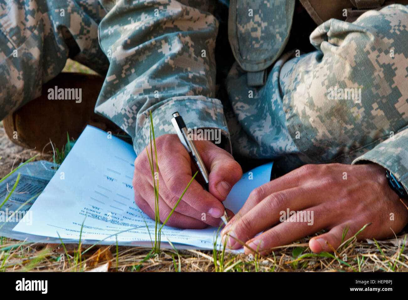 A Best Warrior competitor records the grid coordinates for his lane ...