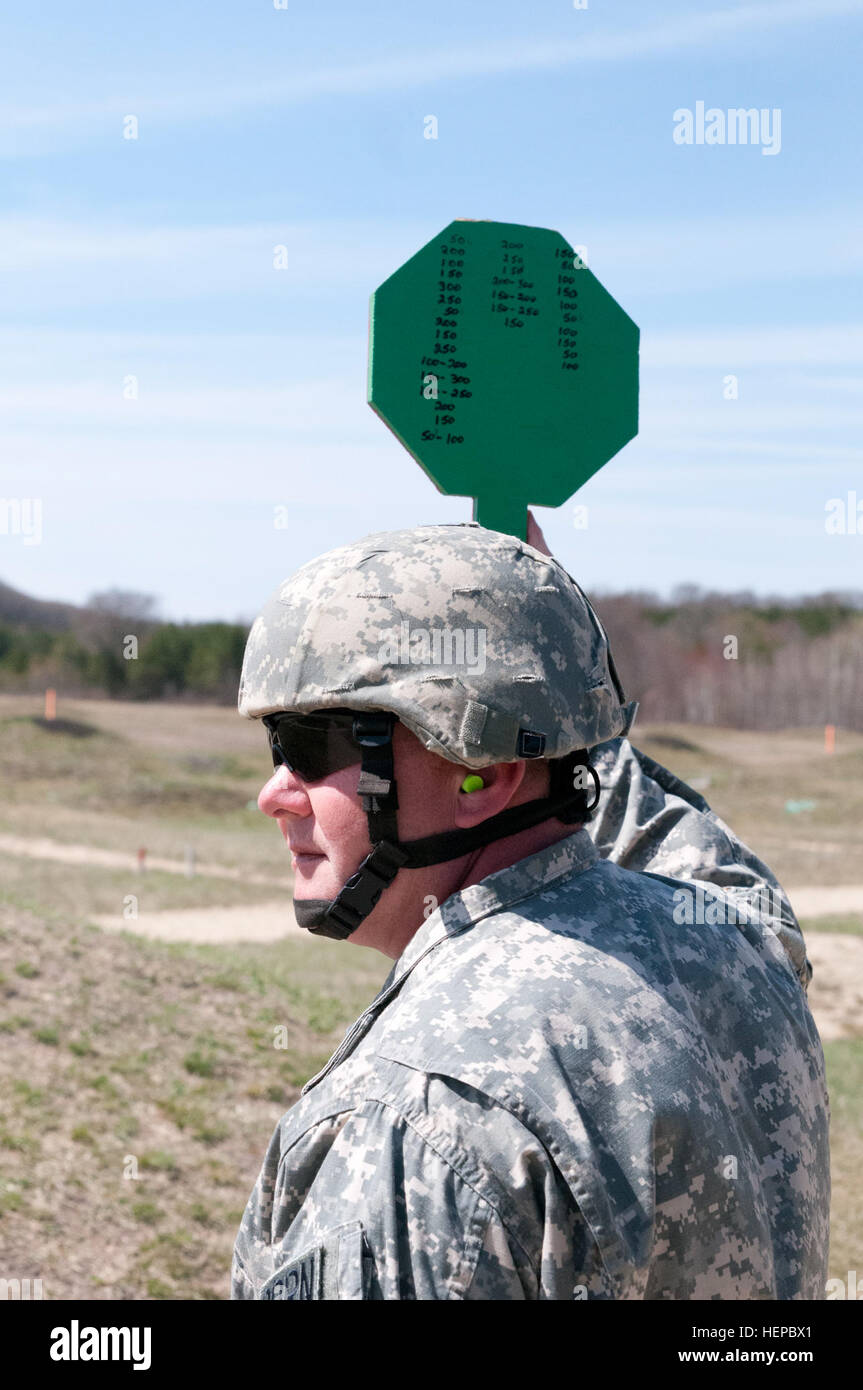 A Best Warrior safety cadre holds a green paddle for "all clear" during ...