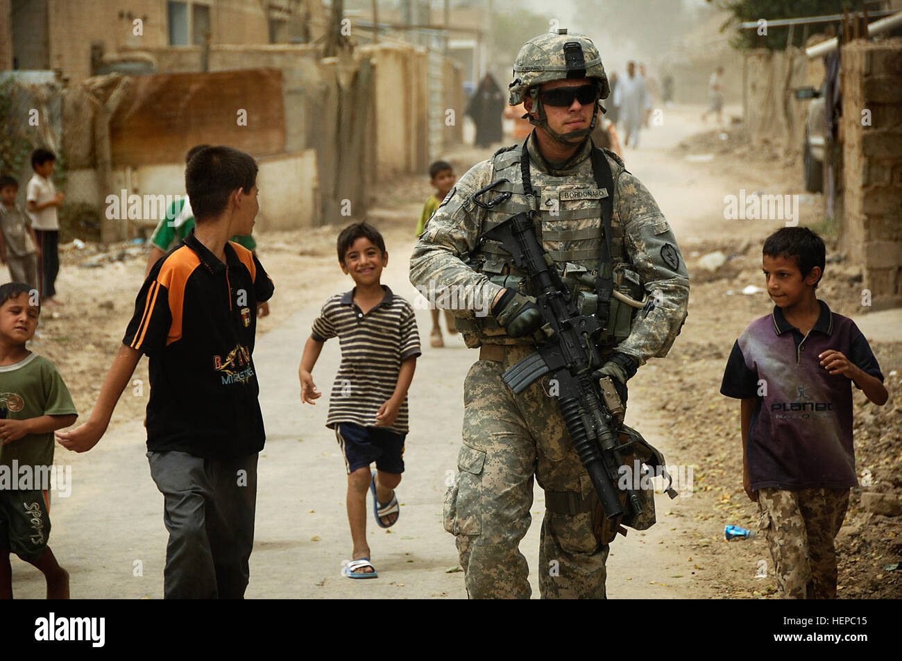 Children swarm around U.S. Army Pfc. Shane Bordonado, 2nd Squadron ...