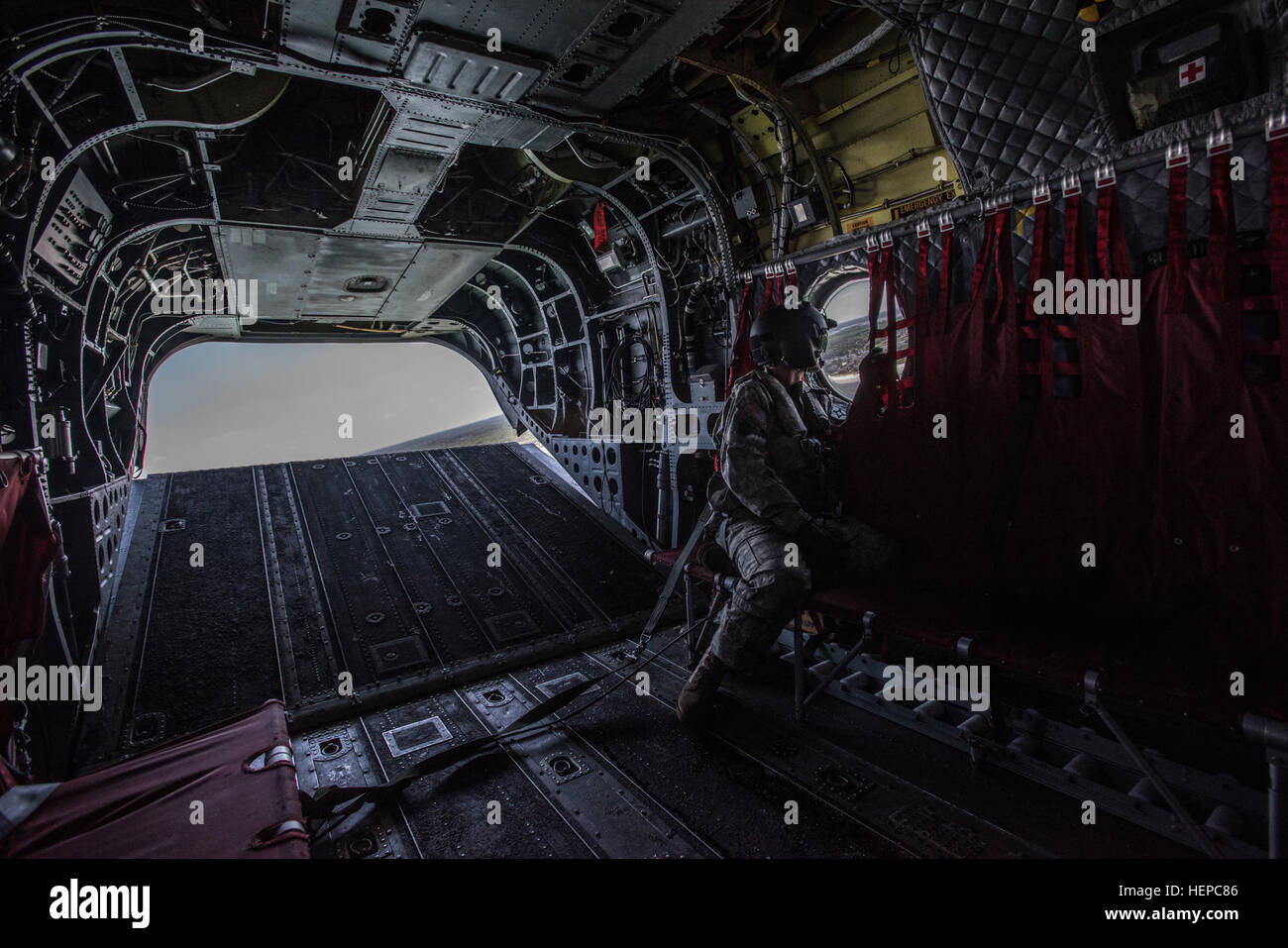 An Army National Guard CH-47 Chinook crew chief scans the landing zone ...