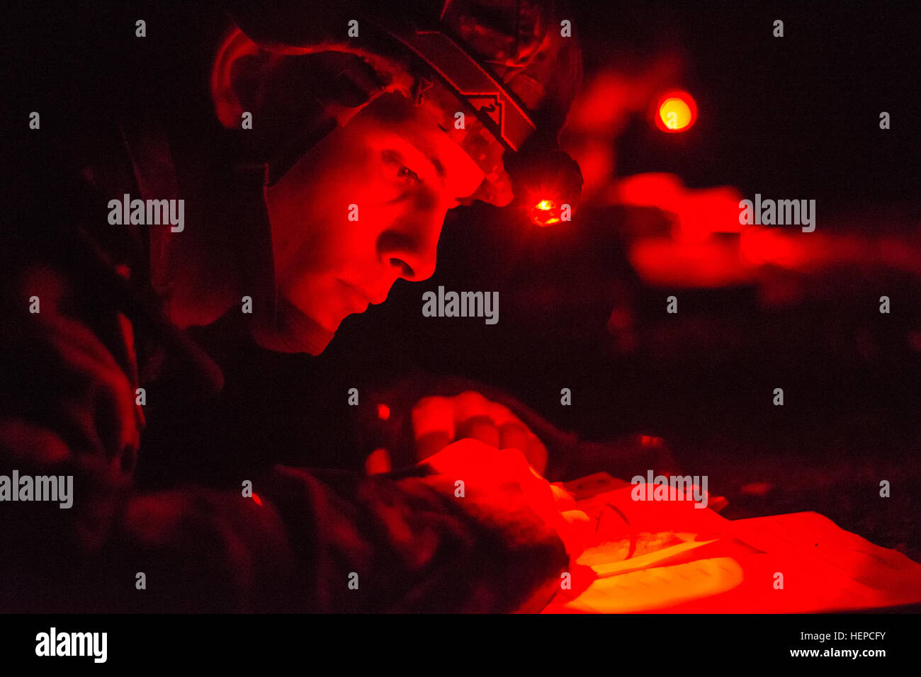A medical logistics specialist plots coordinates during a land ...