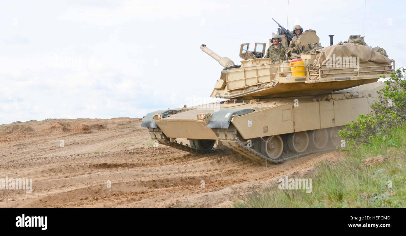 The crew of an M1A2 Abrams Main Battle Tank returns to the staging area ...
