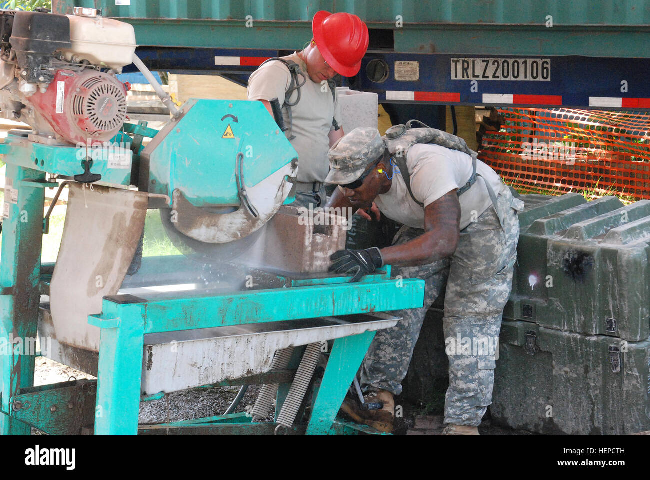 Soldiers from the Colorado Army National Guard cut cinder blocks while ...