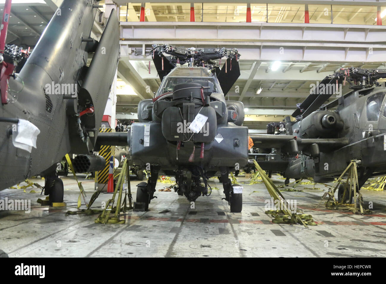 An AH-64 Apache aircraft sits on the cargo bay of a charted vessel ...
