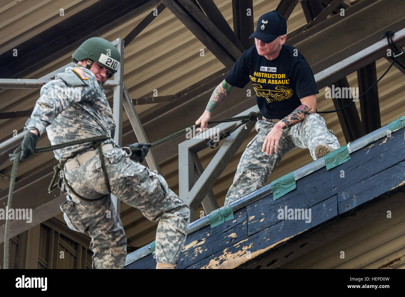 An Air Assault instructor watches as a Soldier repels down the Air ...