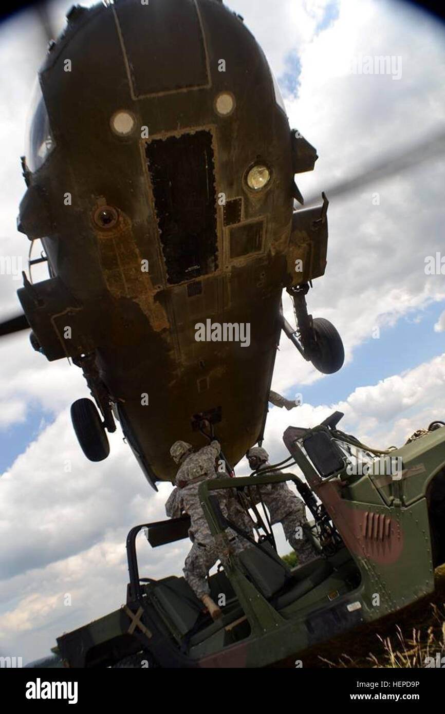 A UH-60 "Black Hawk" helicopter hovers above a disabled Humvee as ...