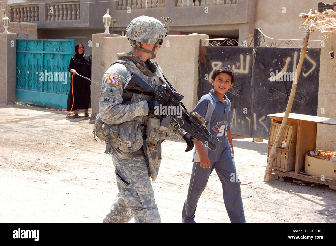 Sgt. Eric Burke, a native of Kettering, Ohio, talks with a young boy ...