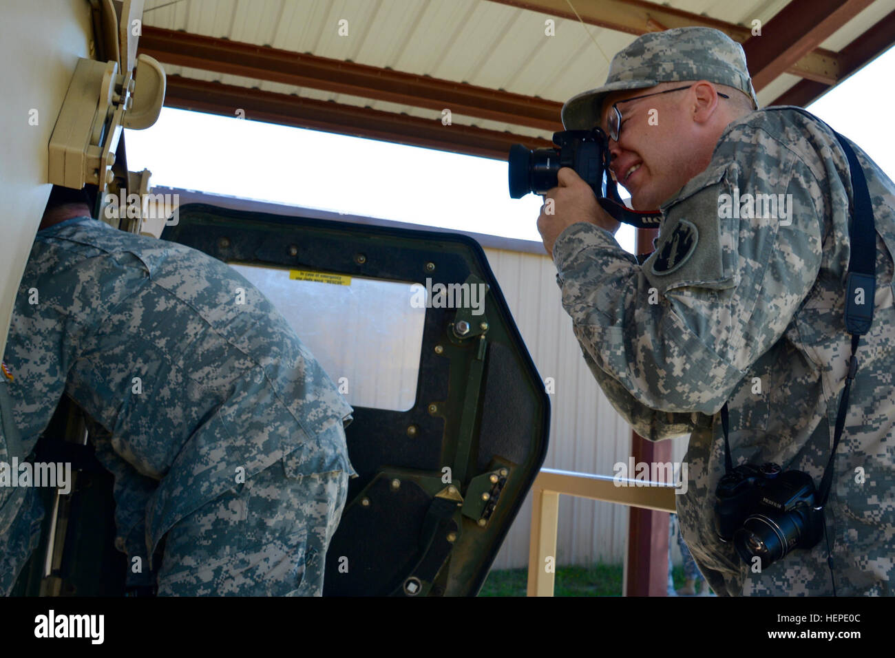 Spc. Ryan Swanson, of the 364th Press Camp Headquarters, photographs ...