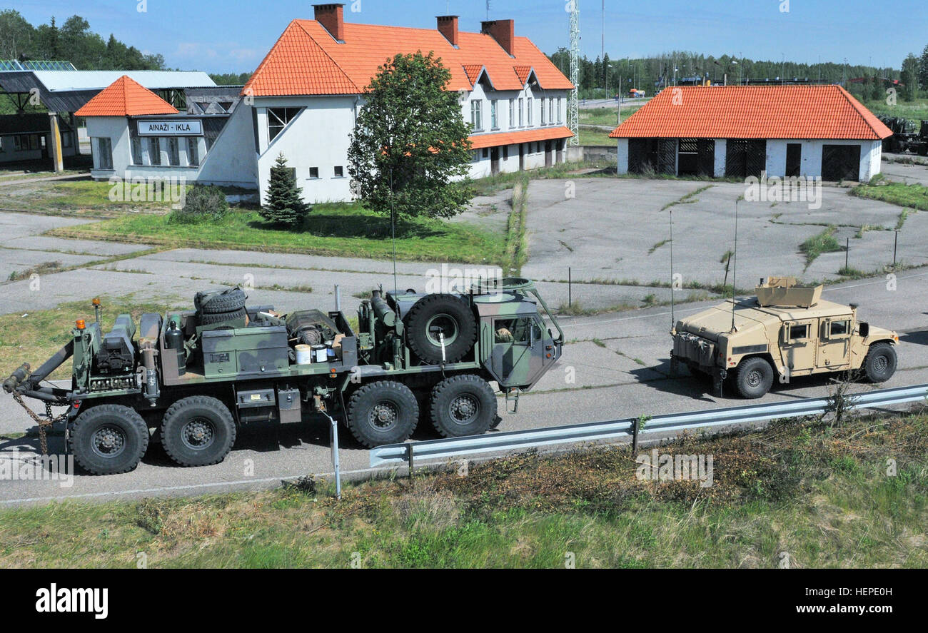 U.S. Army tactical vehicle convoy pauses at the Ainazi-Inkla border ...