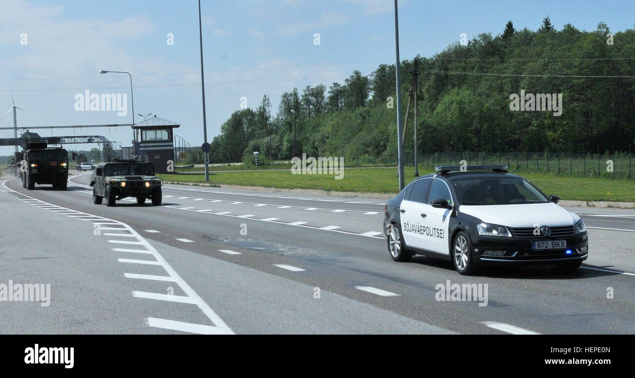 A convoy of U.S. Army vehicles are led by an Estonian police vehicle as ...