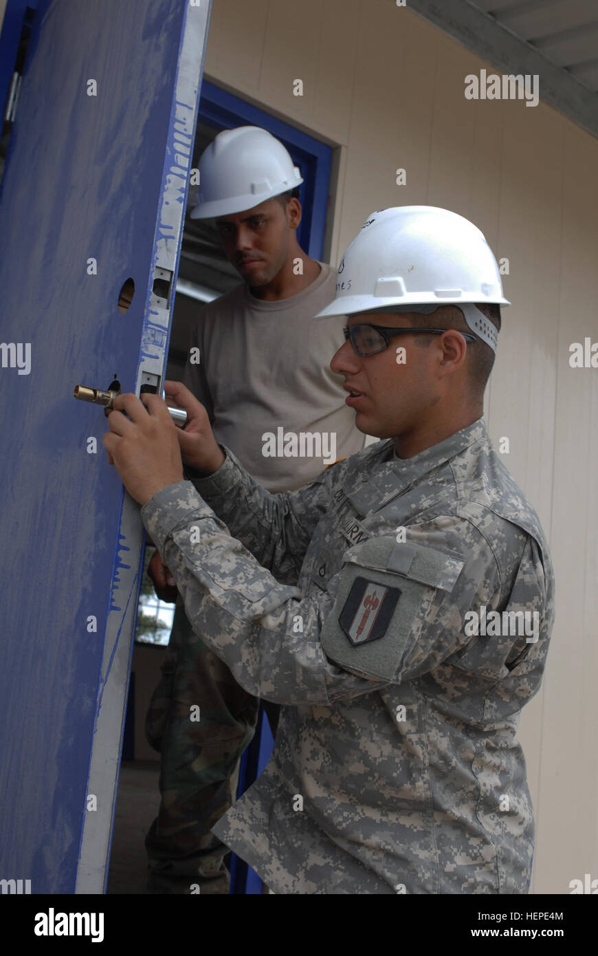 Pfc. Justin Coomes, 716th Engineer Company, installs a doorknob while ...