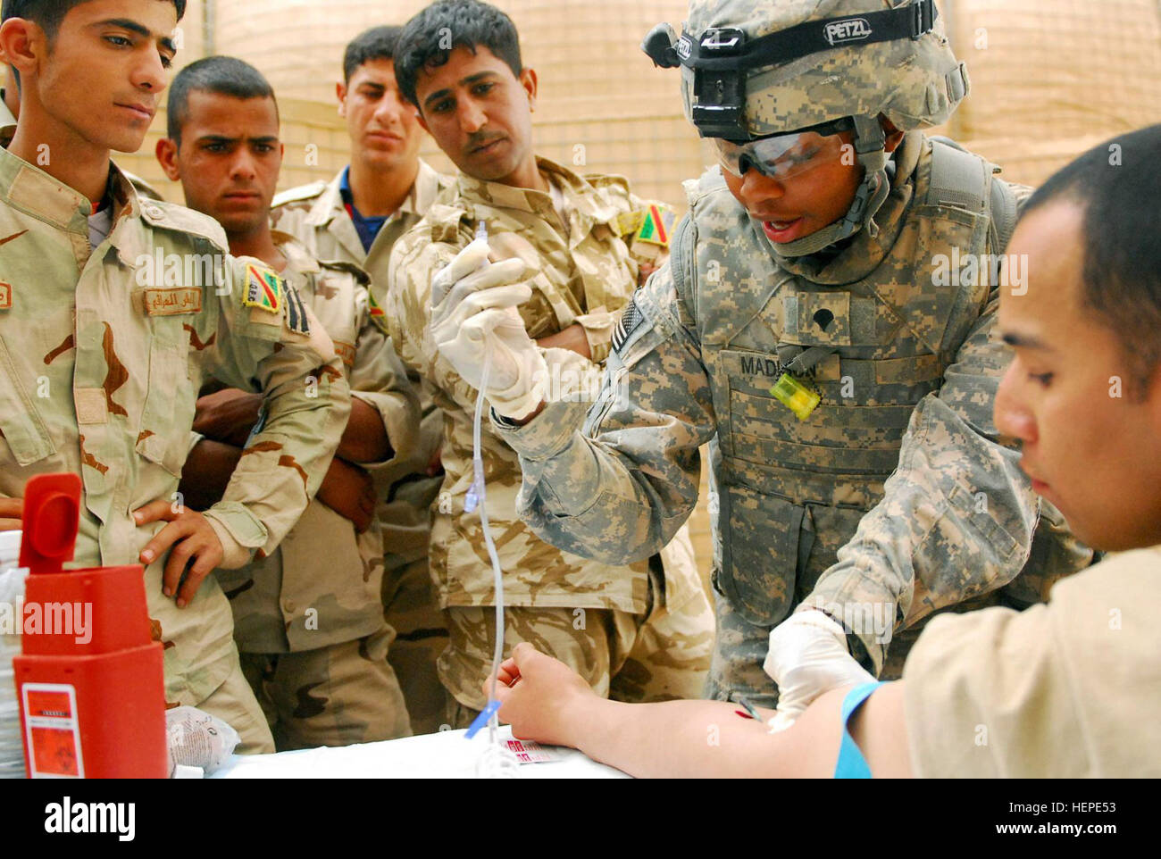 Iraqi army soldiers look on as Spc. Diamond Madison, with C Company ...