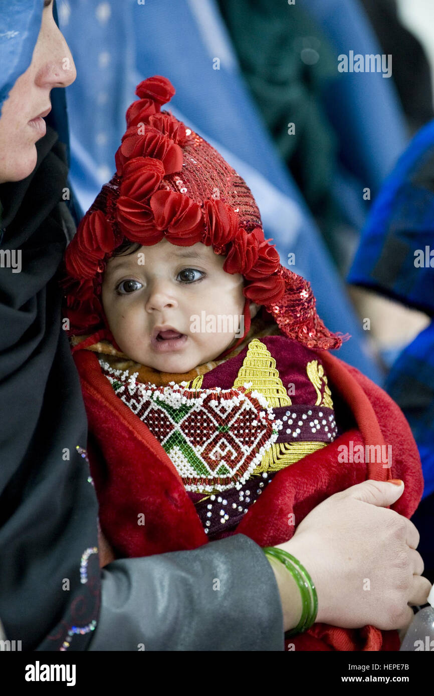 An Afghan mother holds her baby while waiting in the Korean hospital ...