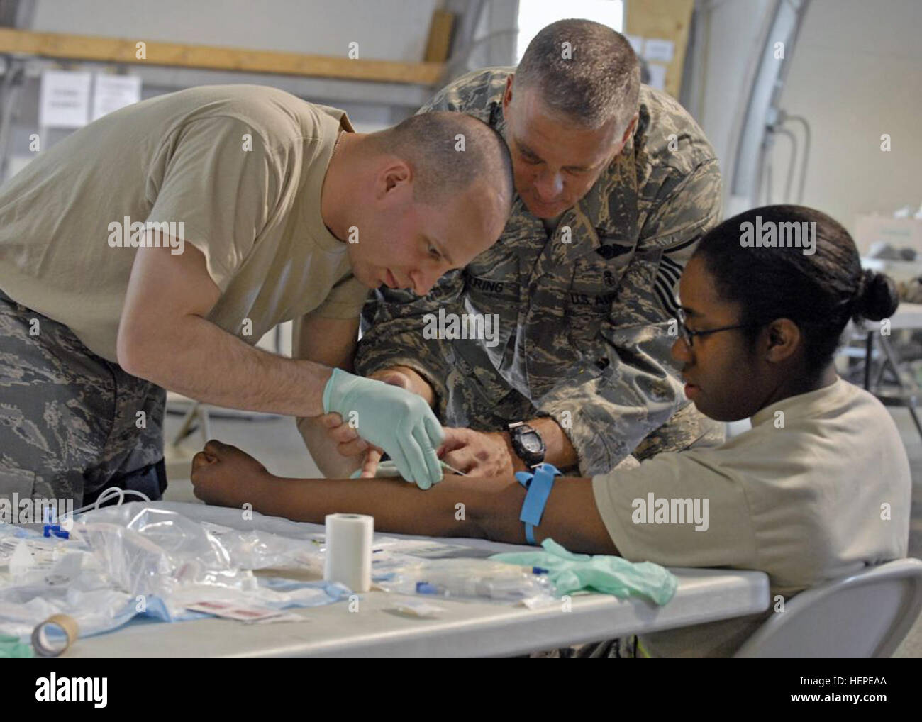 Sen. Airman Albert Lamboy gives Air Force Staff Sgt. Eunice Luster an ...