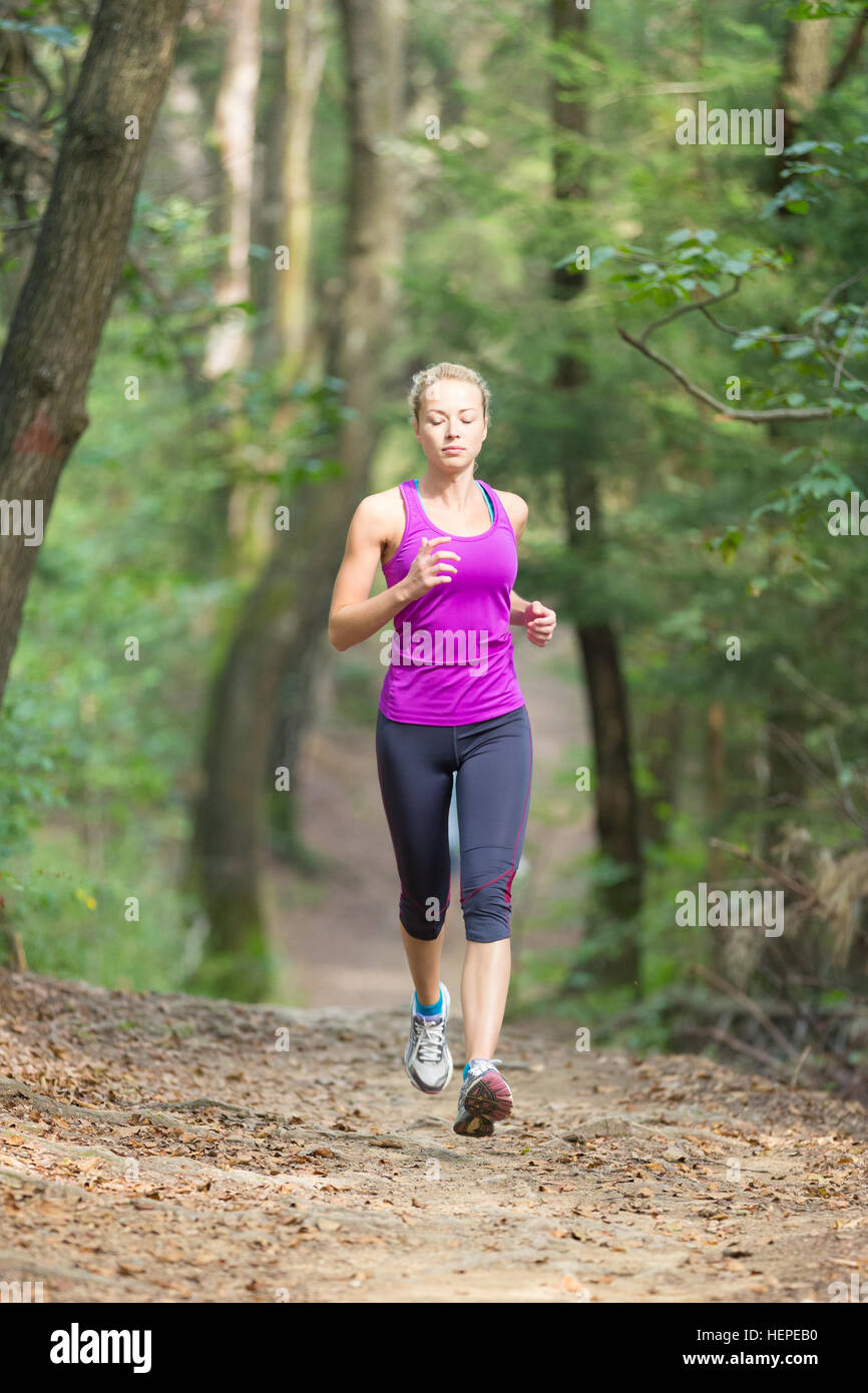 Pretty young girl runner in the forest Stock Photo - Alamy