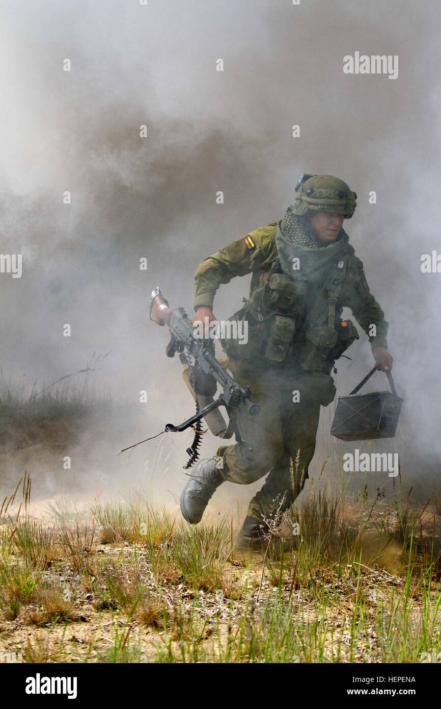 A Lithuanian Land Forces soldier retreats from a foxhole during ...