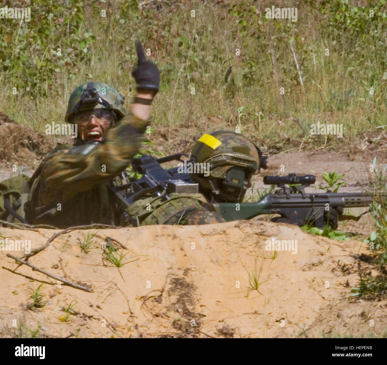 A German Army soldier assigned to 3rd Company, Jager Battalion, signals ...