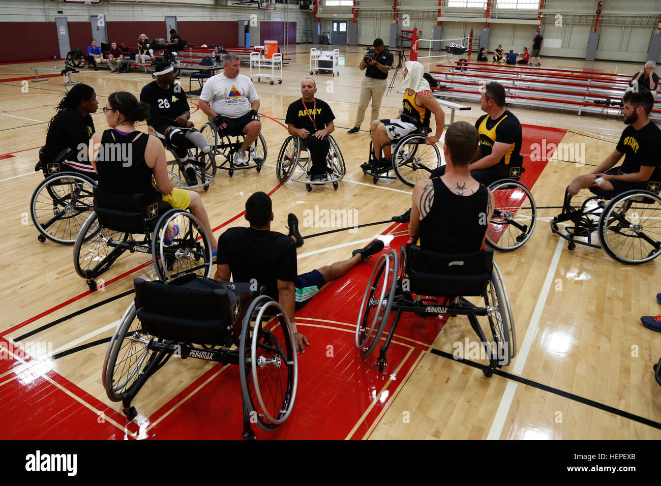 U.S. Army athletes participating in the basketball event gather around ...