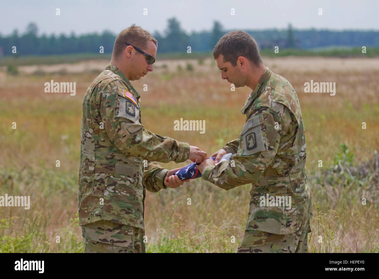 U.S. Army personnel fold an American flag prior to terrain association ...