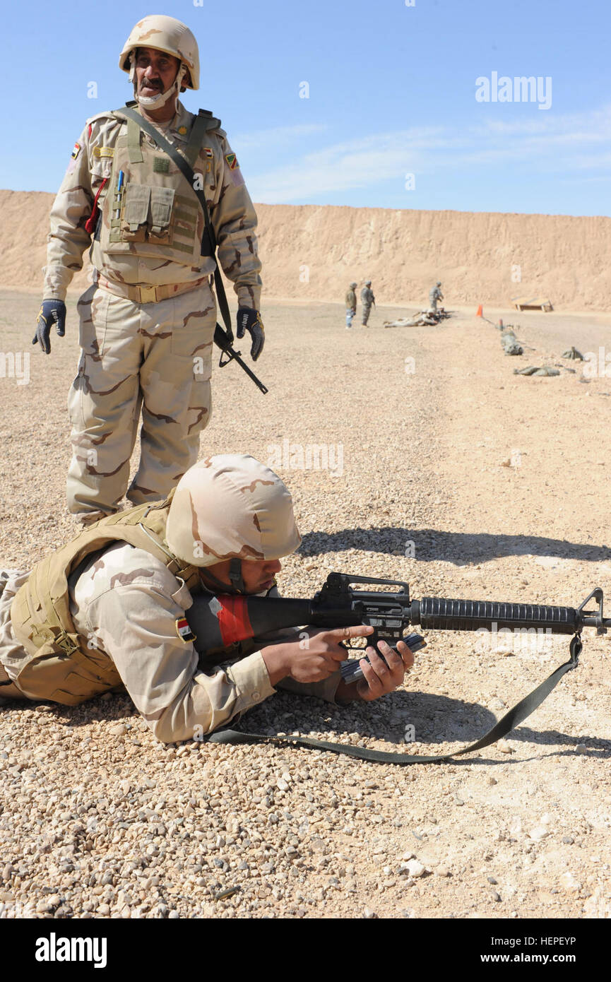 An Iraqi army soldier observes an Iraqi army soldiers practice squad ...