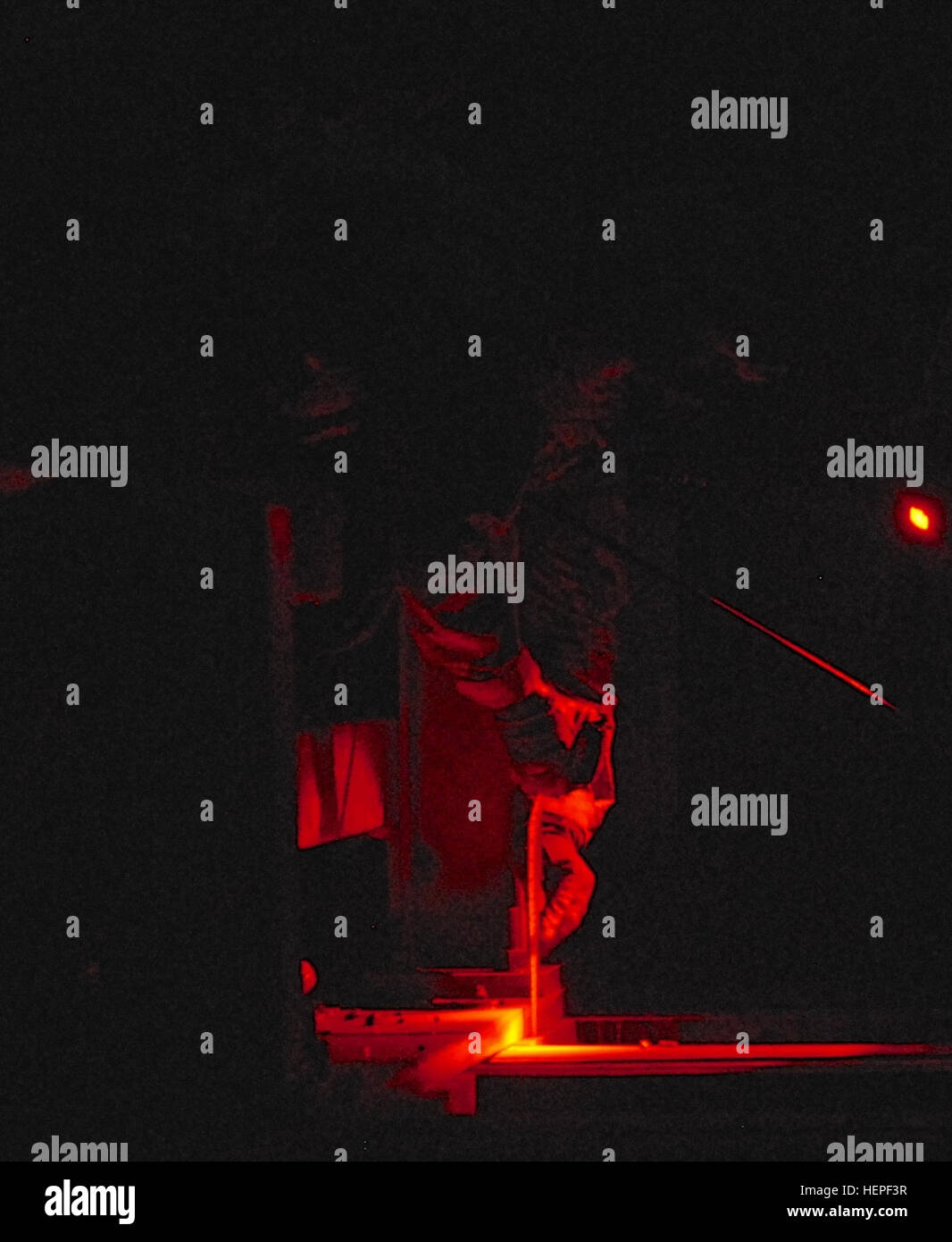 An engineer takes measurements during a bridge reconnaissance with ...