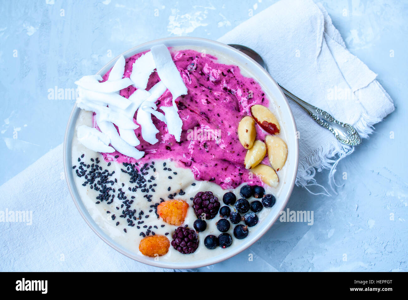 Breakfast purple berry smoothie bowl on a concrete background. Love for ...