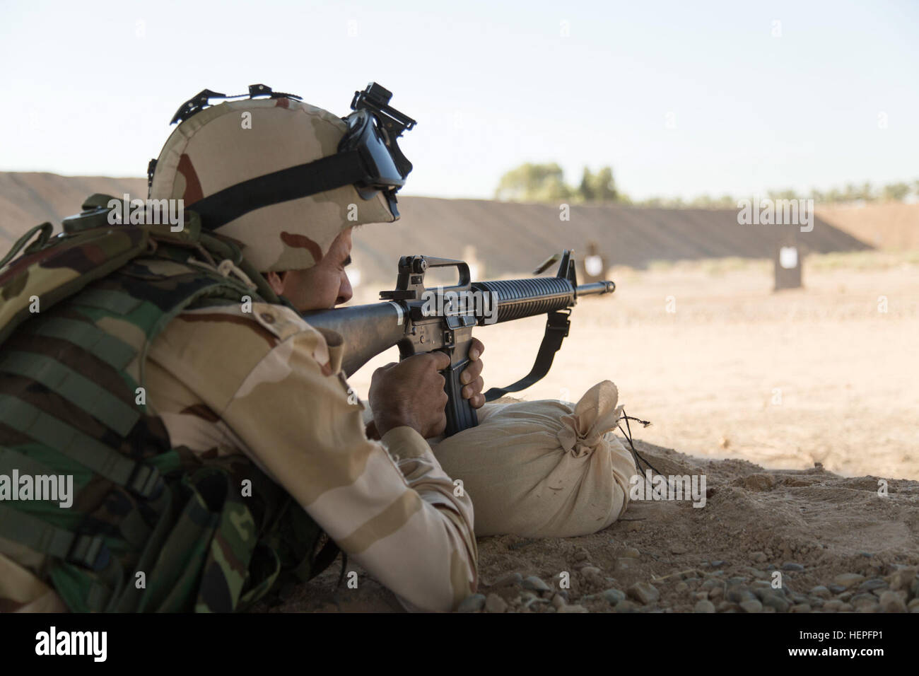 An Iraqi soldier assigned to the 73rd Brigade, 16th Division, fires an ...