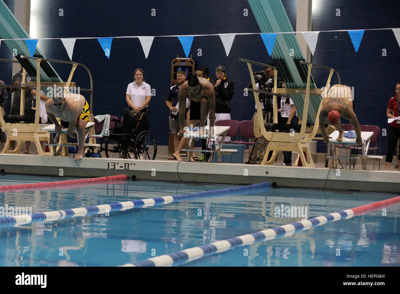 U.S. and British Armed Forces athletes prepare to dive at the start of ...