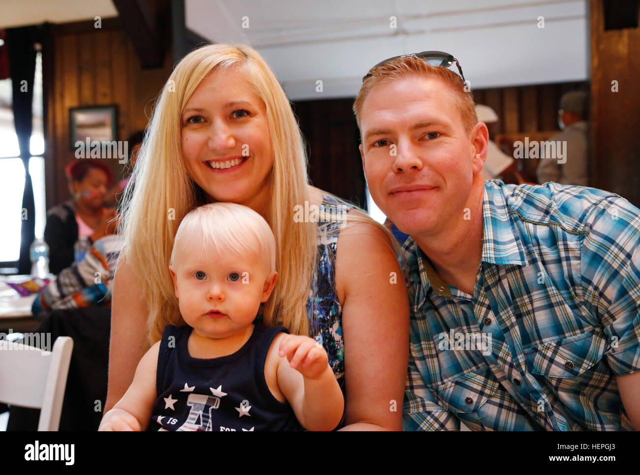 Soldiers of the 55th Signal Company (Combat Camera) hold a family ...