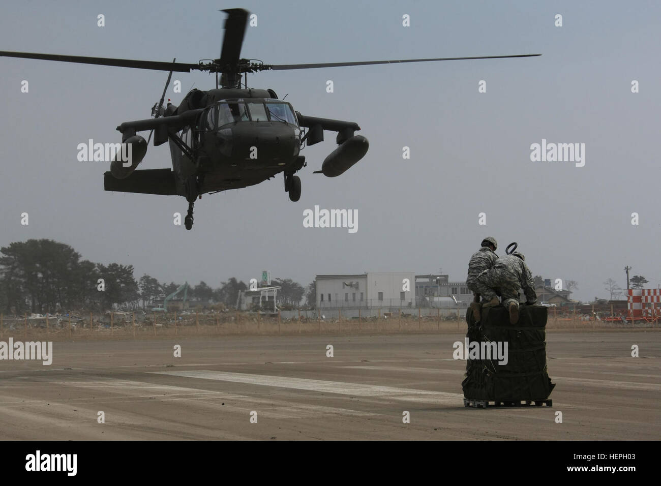 A U.S. Army Japan UH-60 Black Hawk helicopter hovers at Sendai Airport ...