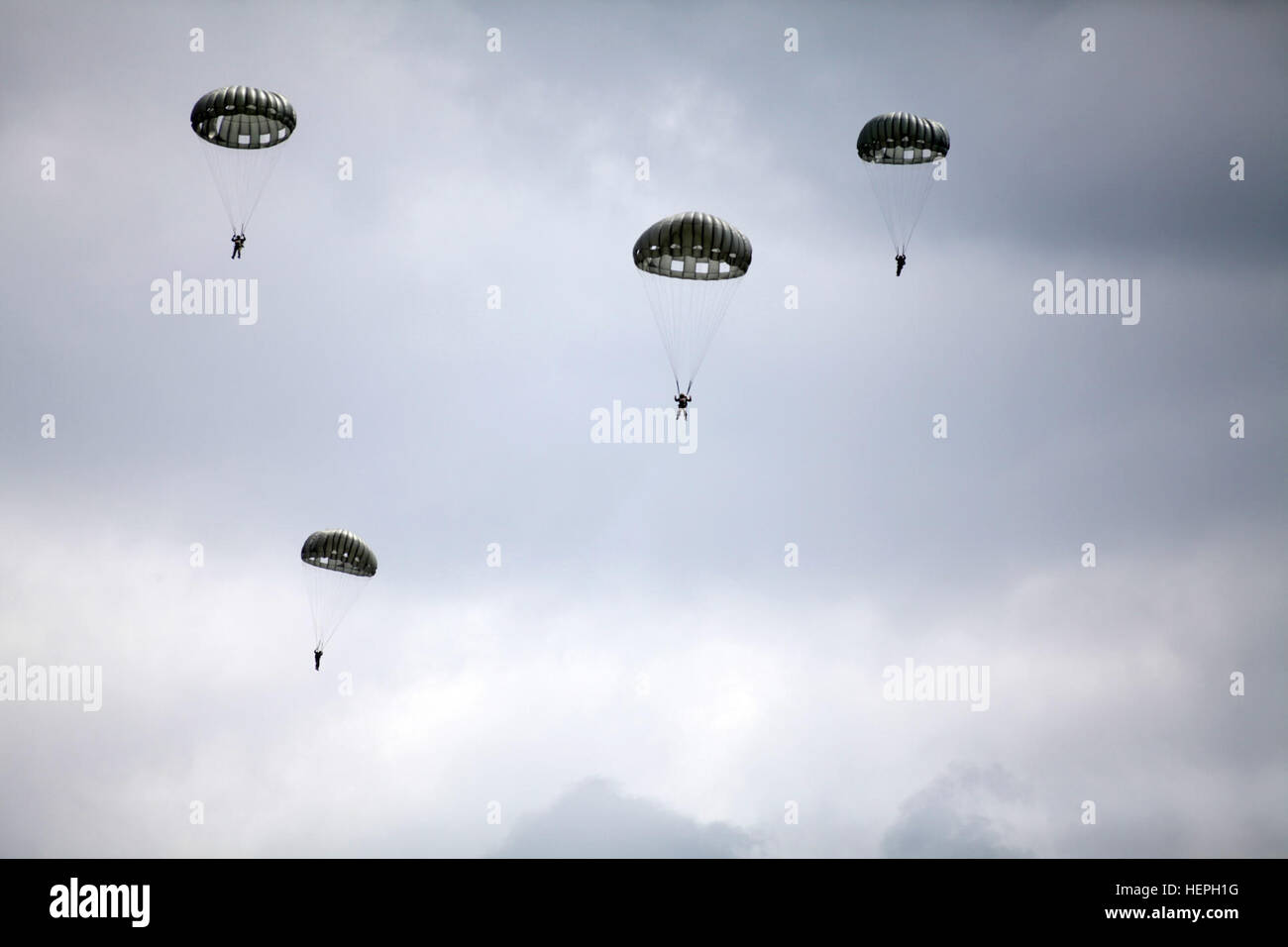 Paratroopers from various countries parachute to the ground during ...