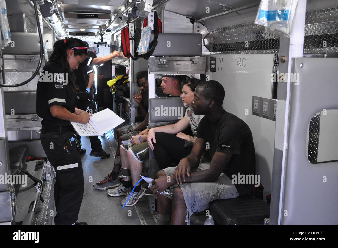 A paramedic with Elite Medical Transport assists role player victims ...