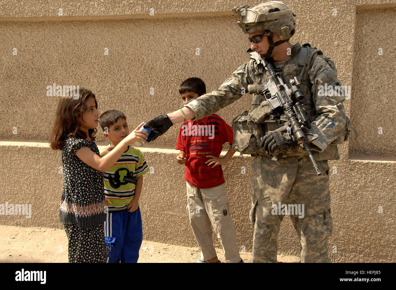 U.S. Army Spc. David Baxter, a native of Senora, CA, makes friends with ...