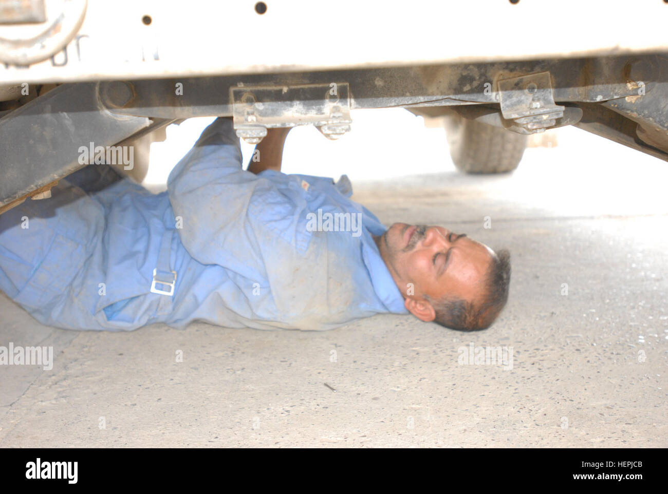 An Iraqi Army mechanic services a Humvee in a motor pool as part of ...
