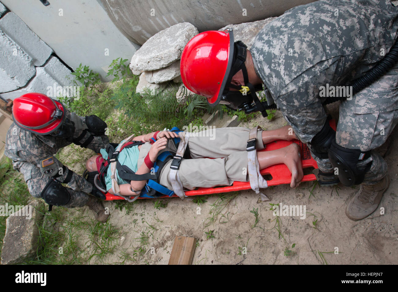 A 92nd Engineer Battalion search and rescue team navigates rubble and a ...