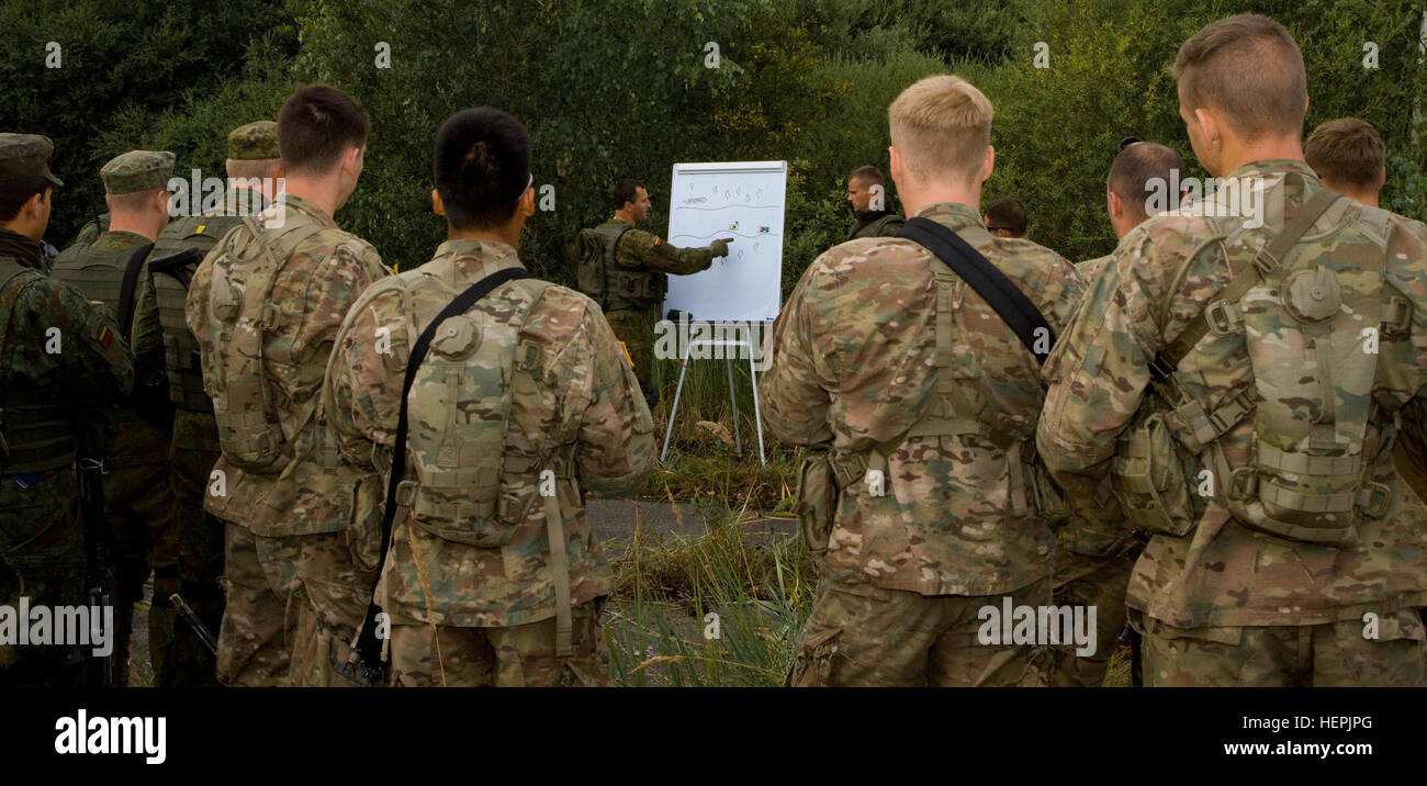 Lithuanian Land Forces Sgt. Orantas Vertelis, center, shows the general ...