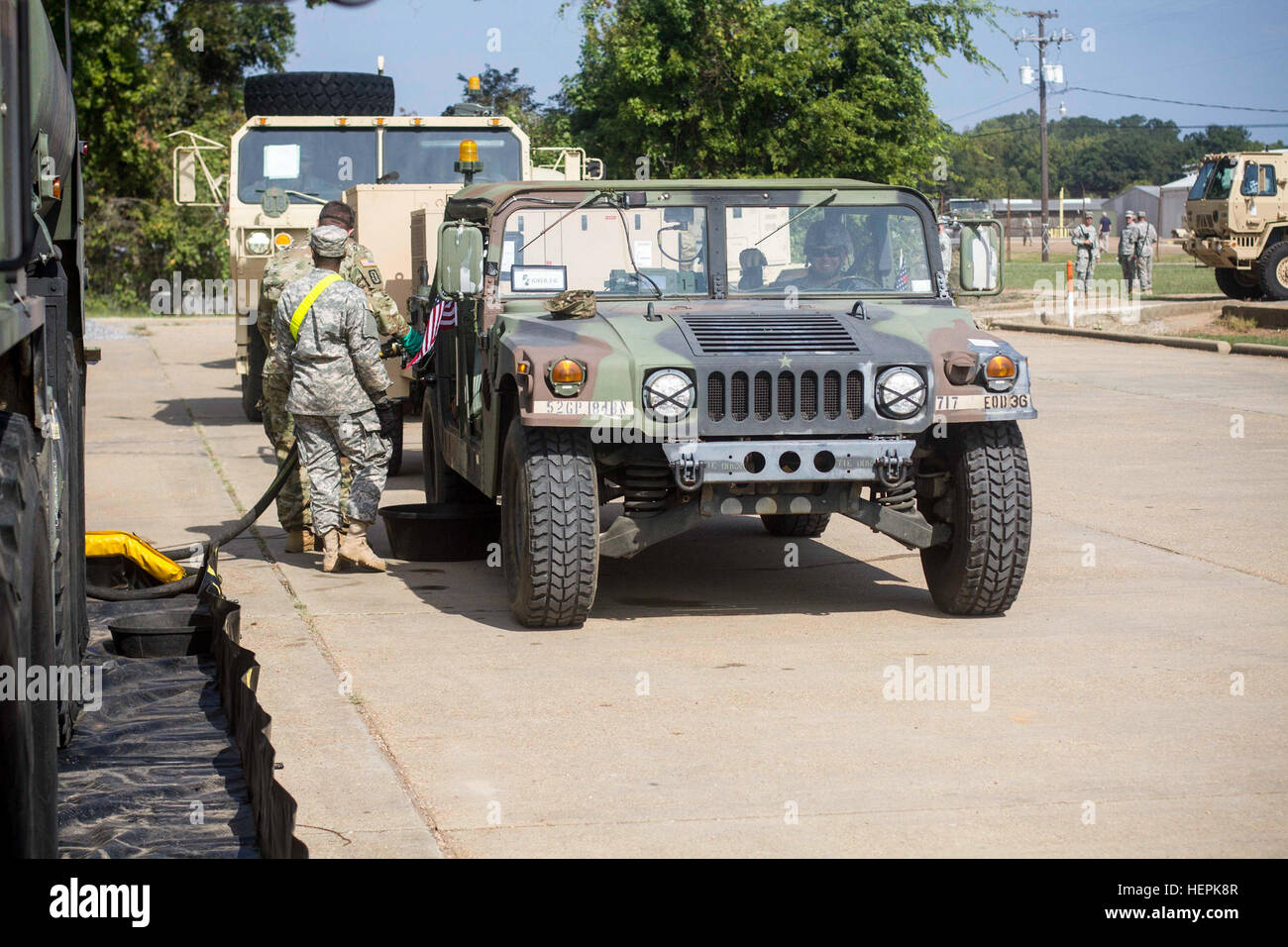 Soldiers stop to fuel up their vehicle before staging them at the ...