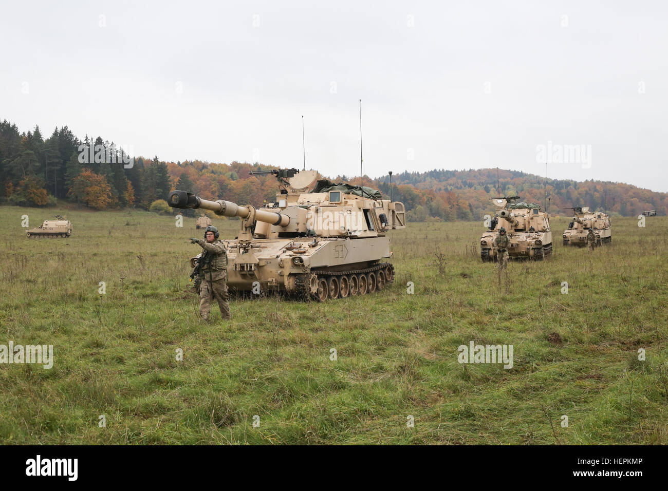 U.S. Army Field Artillery Soldiers guide M109A6 Paladin howitzers to ...