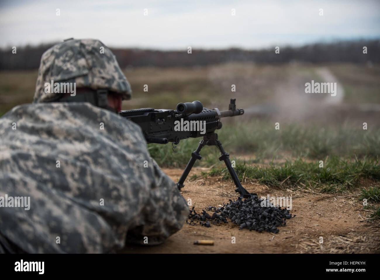 A U.S. Army Reserve military police Soldier shoots an M240B machine gun ...
