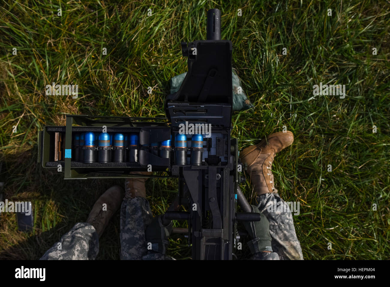A MK19 machine grenade launcher is fed with rounds at a range conducted ...