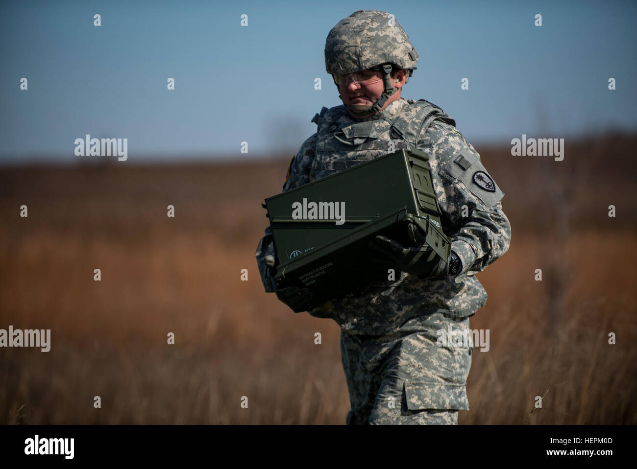 A U.S. Army Reserve military police Soldier carries a can with expired ...
