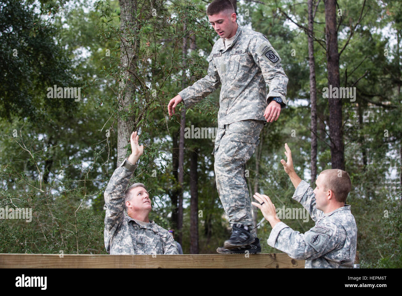 An Army Junior Officer Training Corps cadet crosses a balance-beam on ...