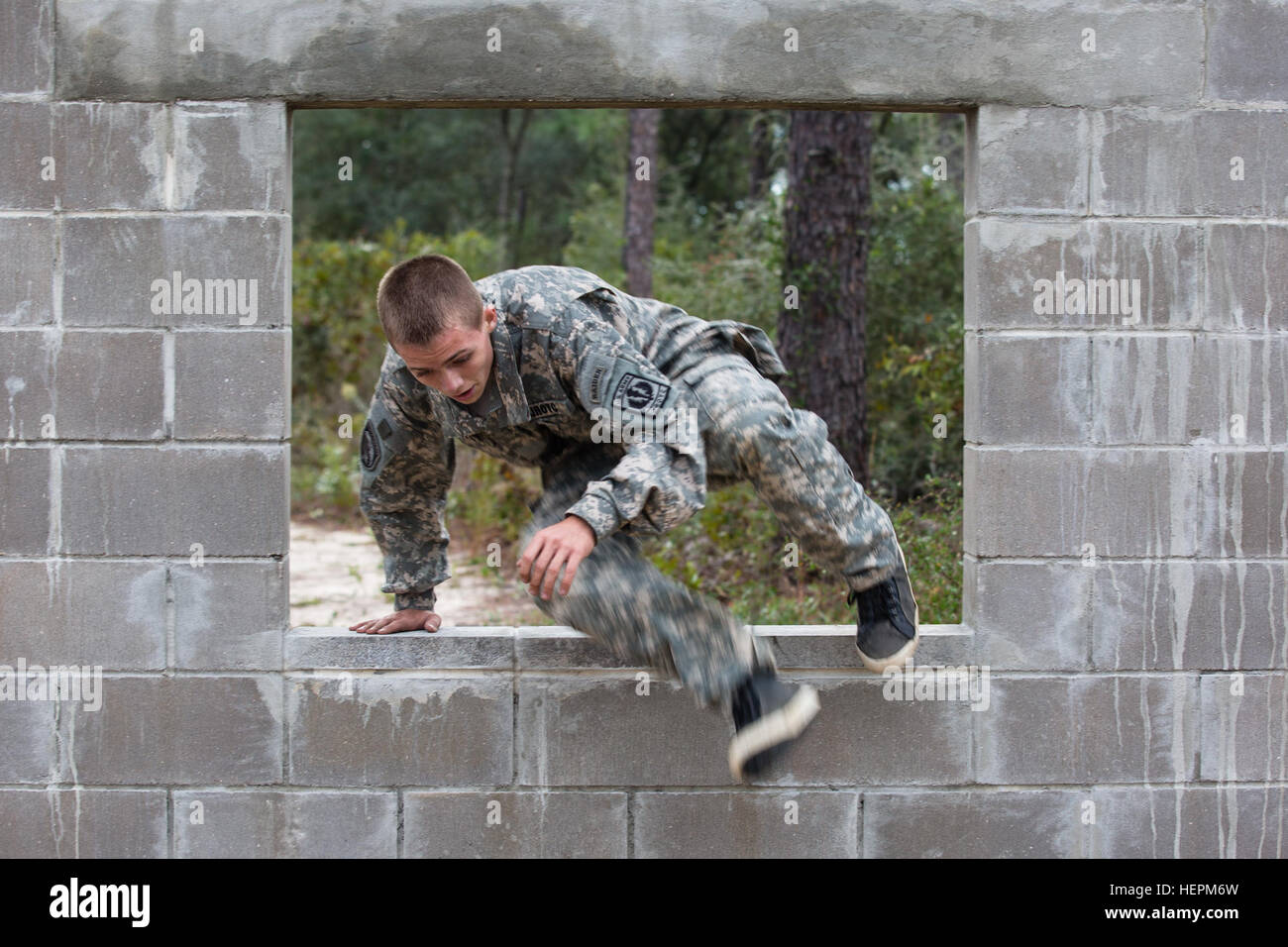An Army Junior Officer Training Corps cadet leaps through a window ...