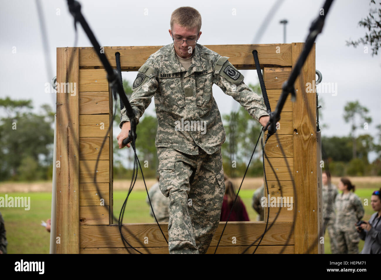 An Army Junior Officer Training Corps cadet navigates a three-rope ...