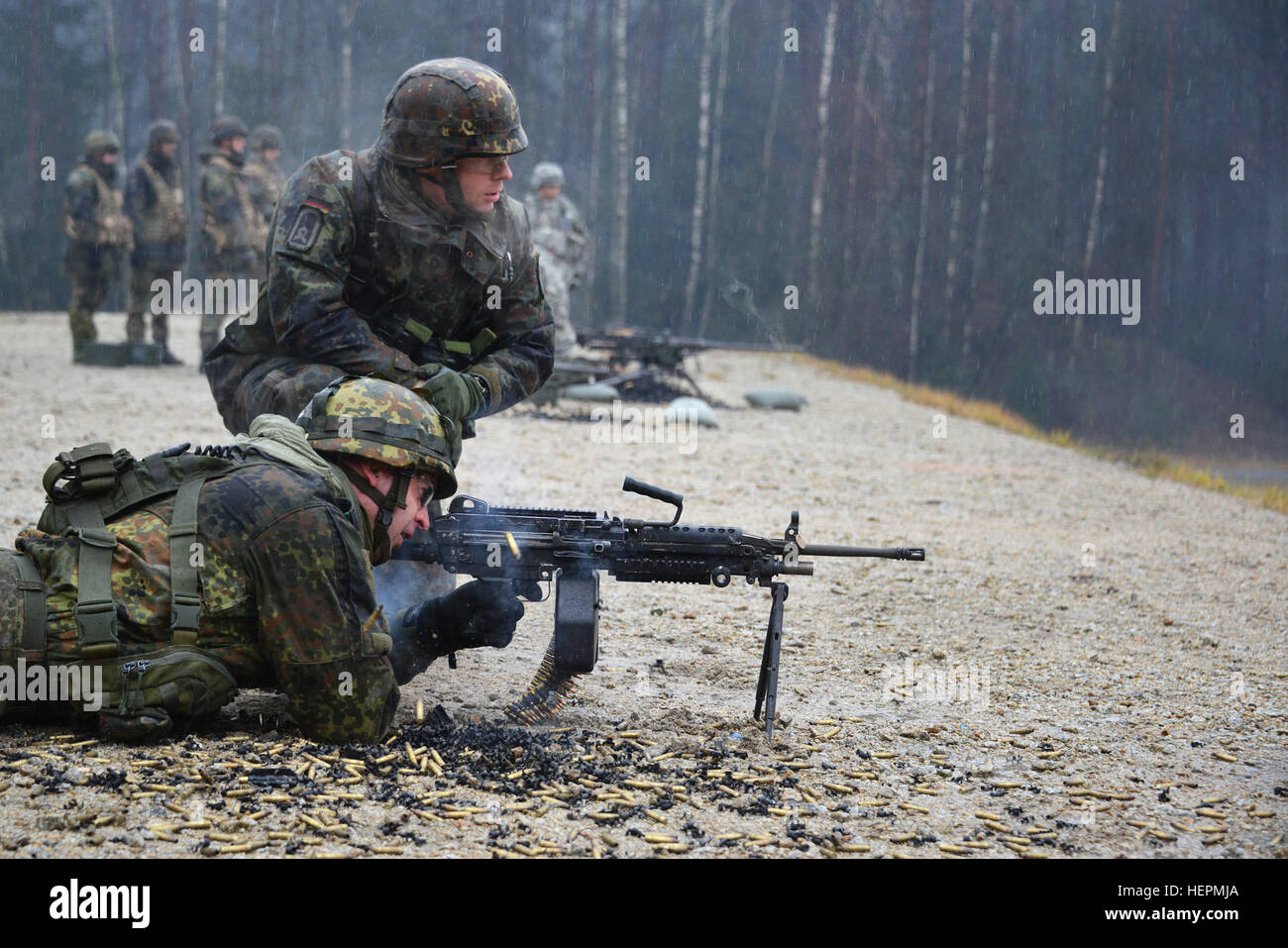 A German soldier fires a M249 light machine gun during a ...