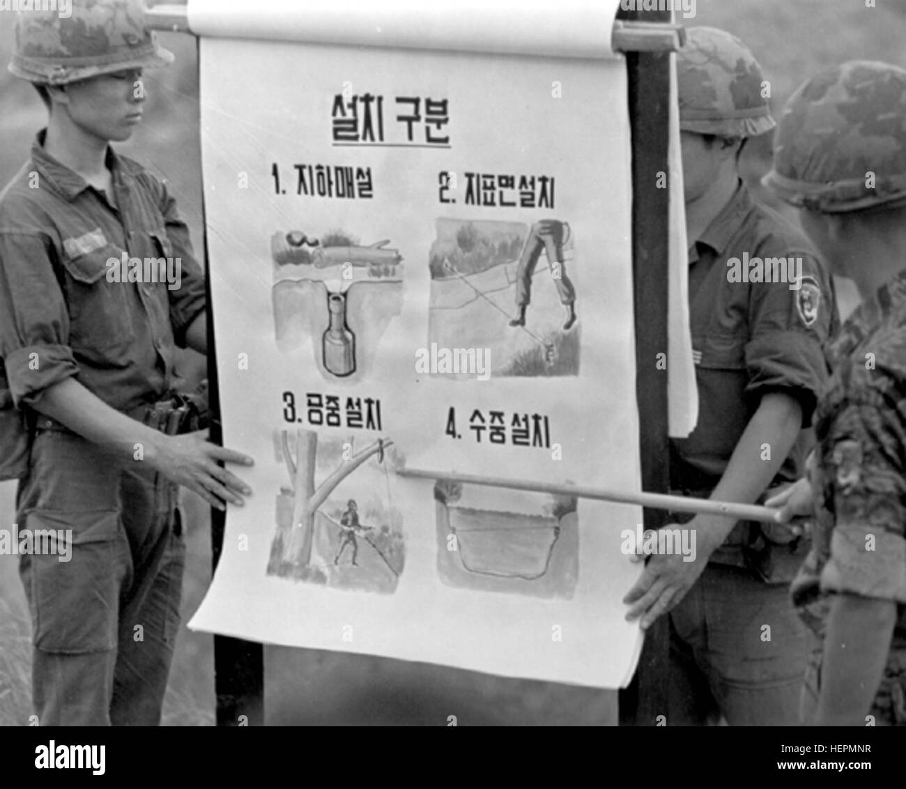 KOREAN TROOPS USE CHART to show villagers types of Viet Cong booby ...