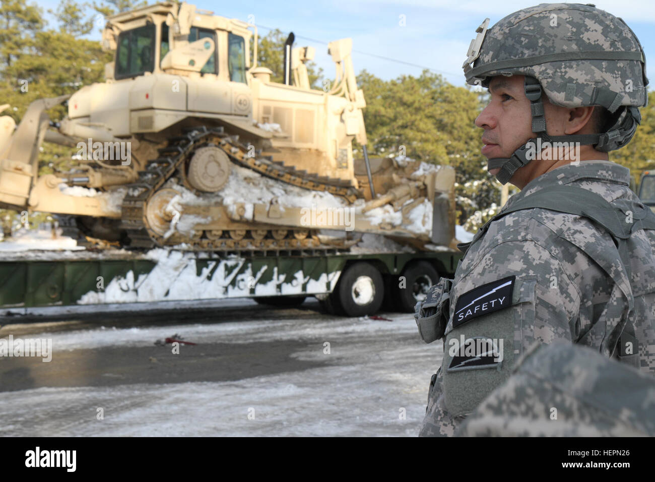 U.S. Army Staff oversee the offloading of a Cat D7R-II Bulldozer at COL ...