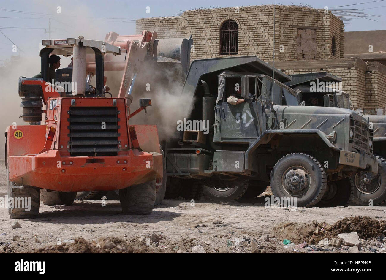 On 11 June, 2003, an Iraqi civilian dumps a load of debris into a dump ...