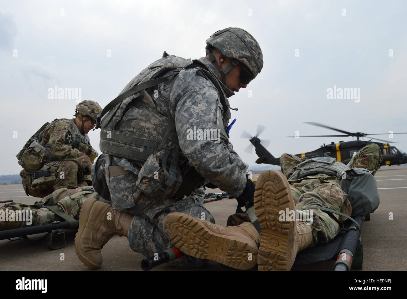 Spc. Logan Duty, foreground, combat medic, and Capt. Hyun Yi, physician ...