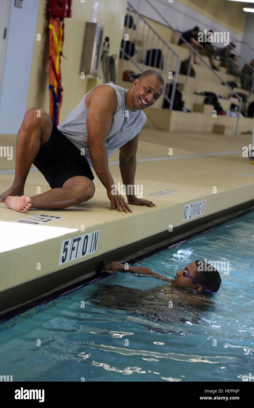 Swim Coach Atiba Wade (left) gives U.S. Army veteran Sgt. Ryan Major ...